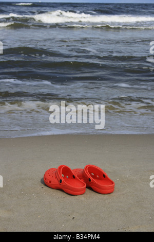 pair of red crocs at the sandy beach. Photo by Willy Matheisl Stock ...