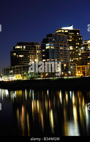 Night modern city skyline with shining neon lights and reflection in ...