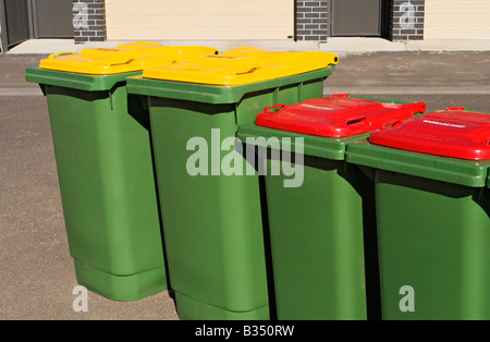Waste Management / Two Recycle bins and three Garbage bins stand ready ...