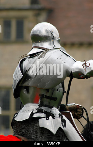 A rear view of the knight in armour watching medieval jousting event ...