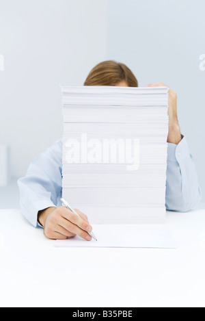 busy man hiding behind a stack of files Stock Photo - Alamy