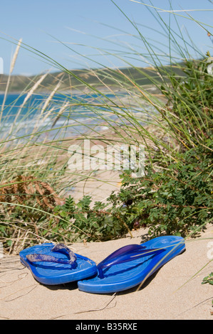 Flip flops discarded on the beach Stock Photo - Alamy