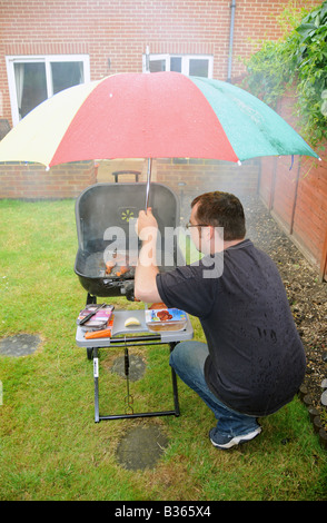 man drinking beer in the rain in a pub beer garden Stock Photo - Alamy