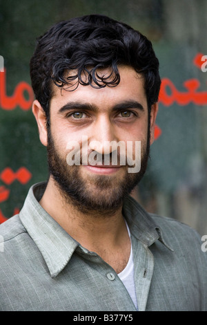 Young handsome bearded Iranian man doctor against brown backgrou Stock ...