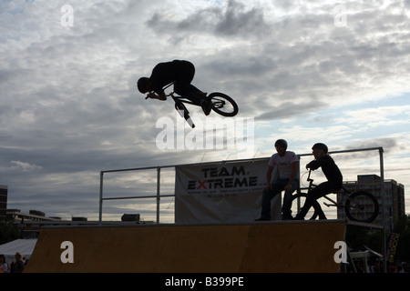 Team Extreme member performing BMX trick in the air on half-pipe Stock ...