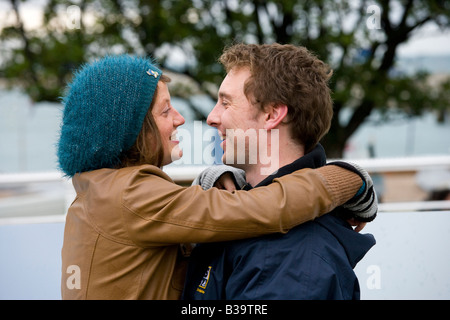 Happy young couple in love embracing on grey background, close up Stock ...