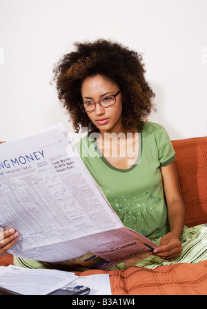 African woman reading newspaper Stock Photo - Alamy