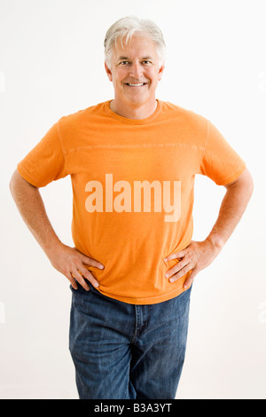 Portrait of smiling happy man standing on gray studio background Stock ...