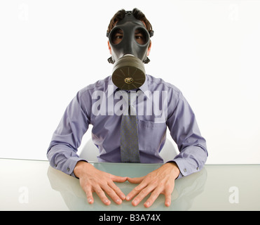 Asian businessman wearing face mask using smartphone in city street ...