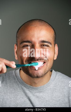 Middle Eastern man brushing teeth Stock Photo - Alamy