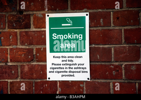 smoking designated area sign mounted in the wall in open space Stock ...
