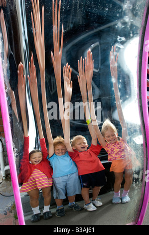 Kids play with a fairground distorting mirror Stock Photo - Alamy