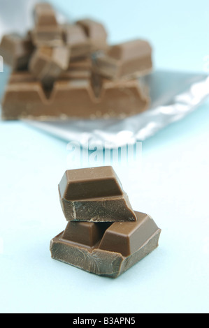 Chocolate isolated against a blue background Stock Photo - Alamy
