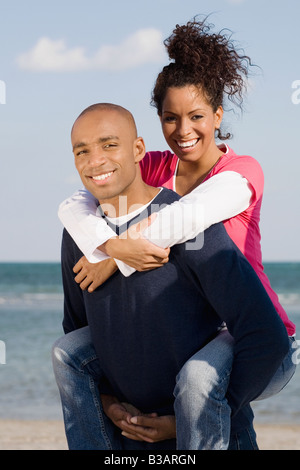 Hispanic man giving girlfriend piggy back ride Stock Photo - Alamy
