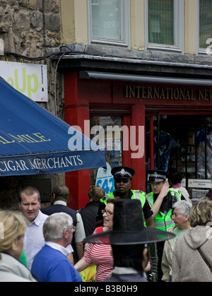 Two police officers, one male, one female, talking with each other in ...