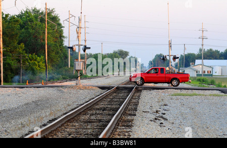 A rural railroad crossing of the CN train line being crossed by a ...