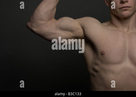A man tensing his bicep muscle Stock Photo - Alamy