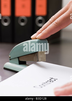 Woman stapling documents Stock Photo - Alamy