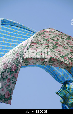 bedding flying in wind on washing line in sun Stock Photo - Alamy