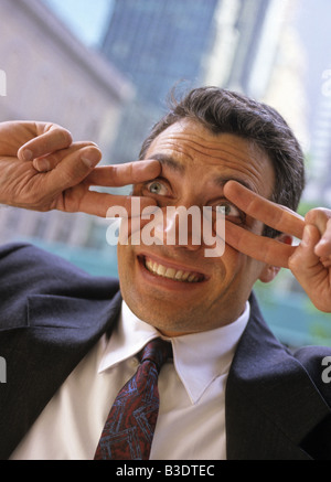 Sleepy Businessman Trying To Keep His Eyes Open At Desk Stock Photo - Alamy