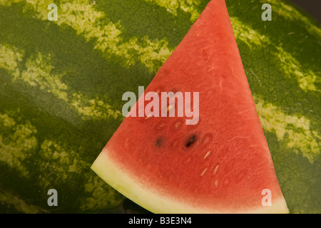 Fresh juicy watermelon with seeds cut into triangles on bright blue ...