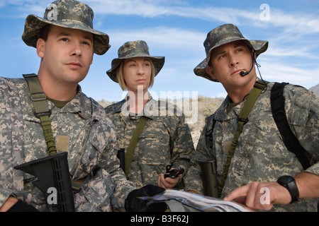 Soldiers in field looking at map Stock Photo - Alamy