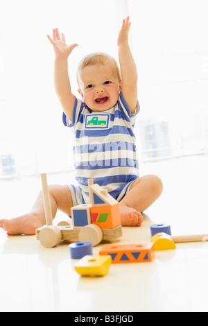 Adorable baby boy learning to crawl and playing with colorful rainbow ...
