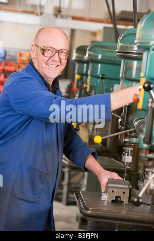 Man working at machine in factory Stock Photo - Alamy