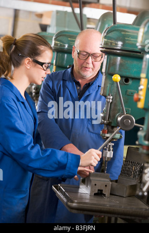 Two machinists working on machine Stock Photo - Alamy