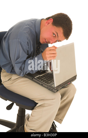 A handsome businessman is working on his lap top while his female ...
