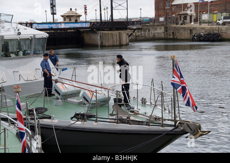Royal Navy sailor mopping the deck of HMS Ranger at the Tall Ships race ...