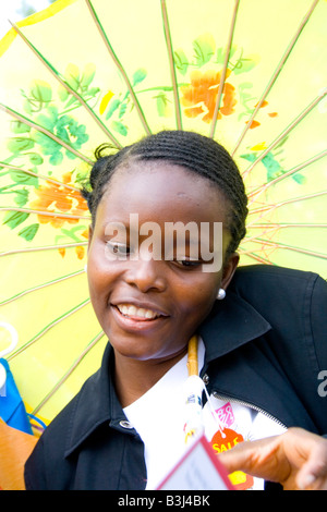 Young african american woman shopkeeper writing on notebook at clothing ...