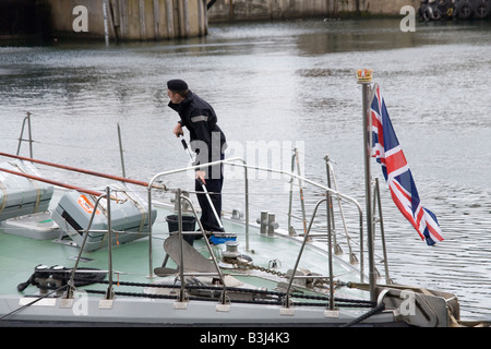 Royal Navy sailor mopping the deck of HMS Ranger at the Tall Ships race ...