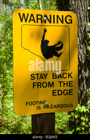 Hazardous footing warning sign on hiking trail behind the Tyler Bend ...