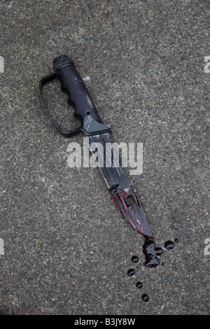Combat knife with blood drops used in a crime in a lane or alley Stock ...