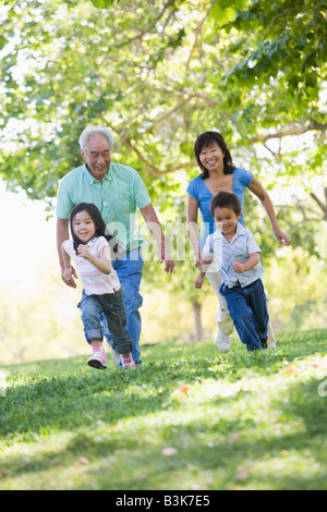 Happy grandparents Asian family enjoy playing toy block with little daughter and mother together ...