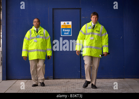 TWO SECURITY GUARDS PATROL THE PERIMETER OF SECURE PREMISES UK Stock ...