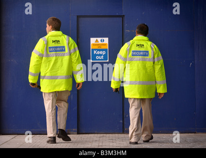 TWO SECURITY GUARDS PATROL THE PERIMETER OF SECURE PREMISES UK Stock ...