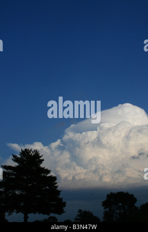 Large white thunderstorm clouds and blue sky with the Calgary Tower and ...