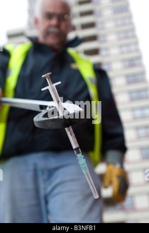 Picking up discarded needles Stock Photo - Alamy