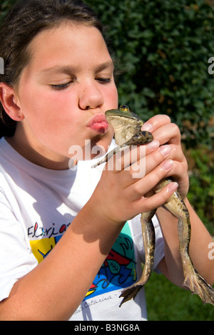 11 year old girl kissing a bullfrog in Boise Idaho Stock Photo - Alamy