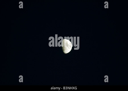 half a moon as seen from the earth with a blue background Stock Photo ...