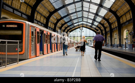 Passengers on platform by train at Piraeus Metro Station, Athens ...