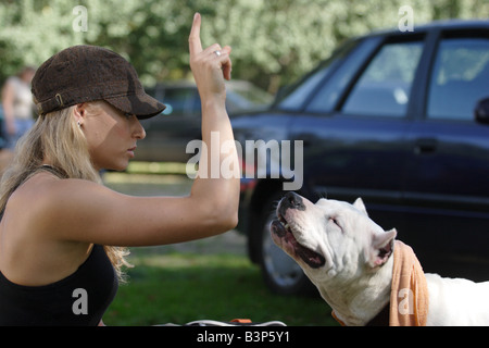 A woman with her Pit Bull before competitions during Pit Bull Show in ...