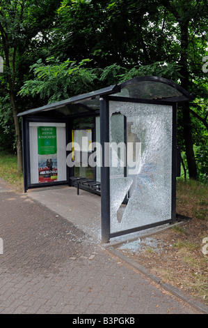 A damaged with broken glasses bus stop. The aftermath of the anti ...
