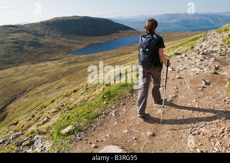 Single female hiker hikes normal route trail towards summit of Ben ...