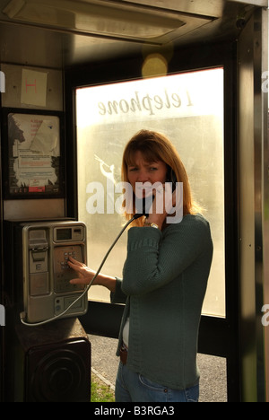 Mature Woman Using A Payphone Stock Photo - Alamy