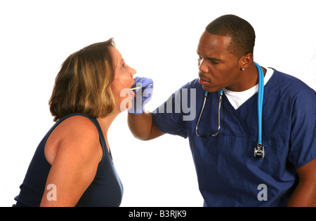 Young professional African-American medical doctor standing over desk ...