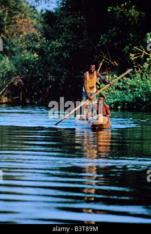 Two fishermen in dugout canoe raising scoop net on Congo River near ...