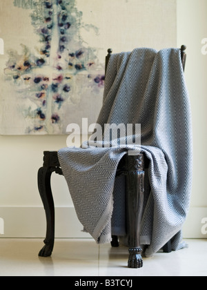 Throw draped over a chair Stock Photo - Alamy